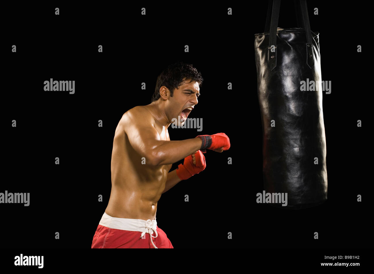 Male boxer showing aggression during practice Stock Photo - Alamy