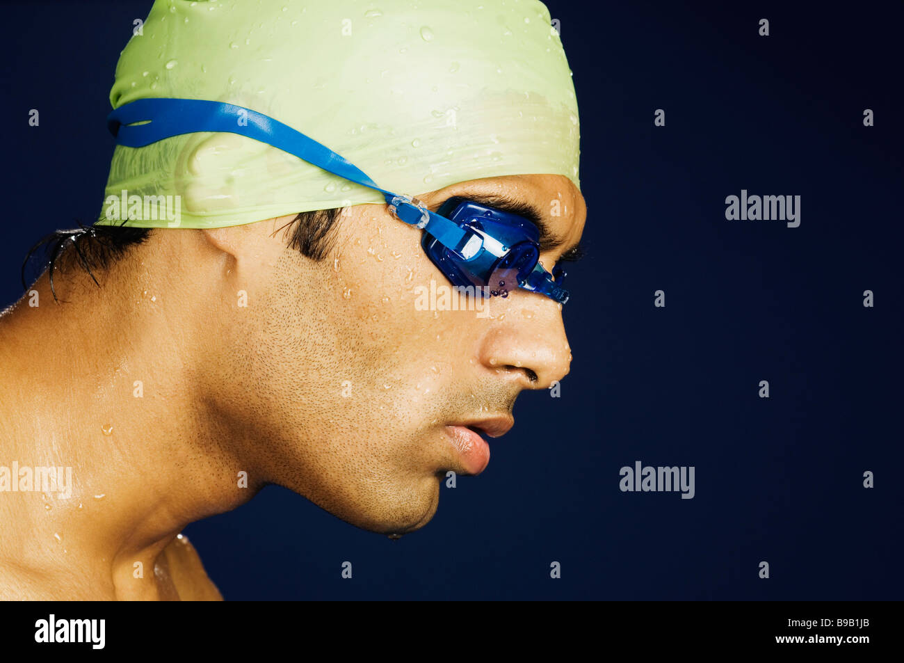 Man wearing a swimming cap and swimming goggles Stock Photo - Alamy