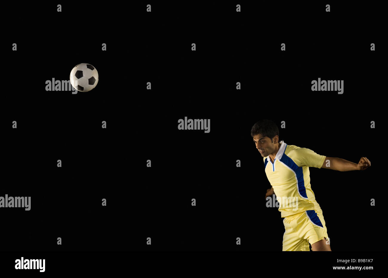 Man heading a soccer ball Stock Photo - Alamy