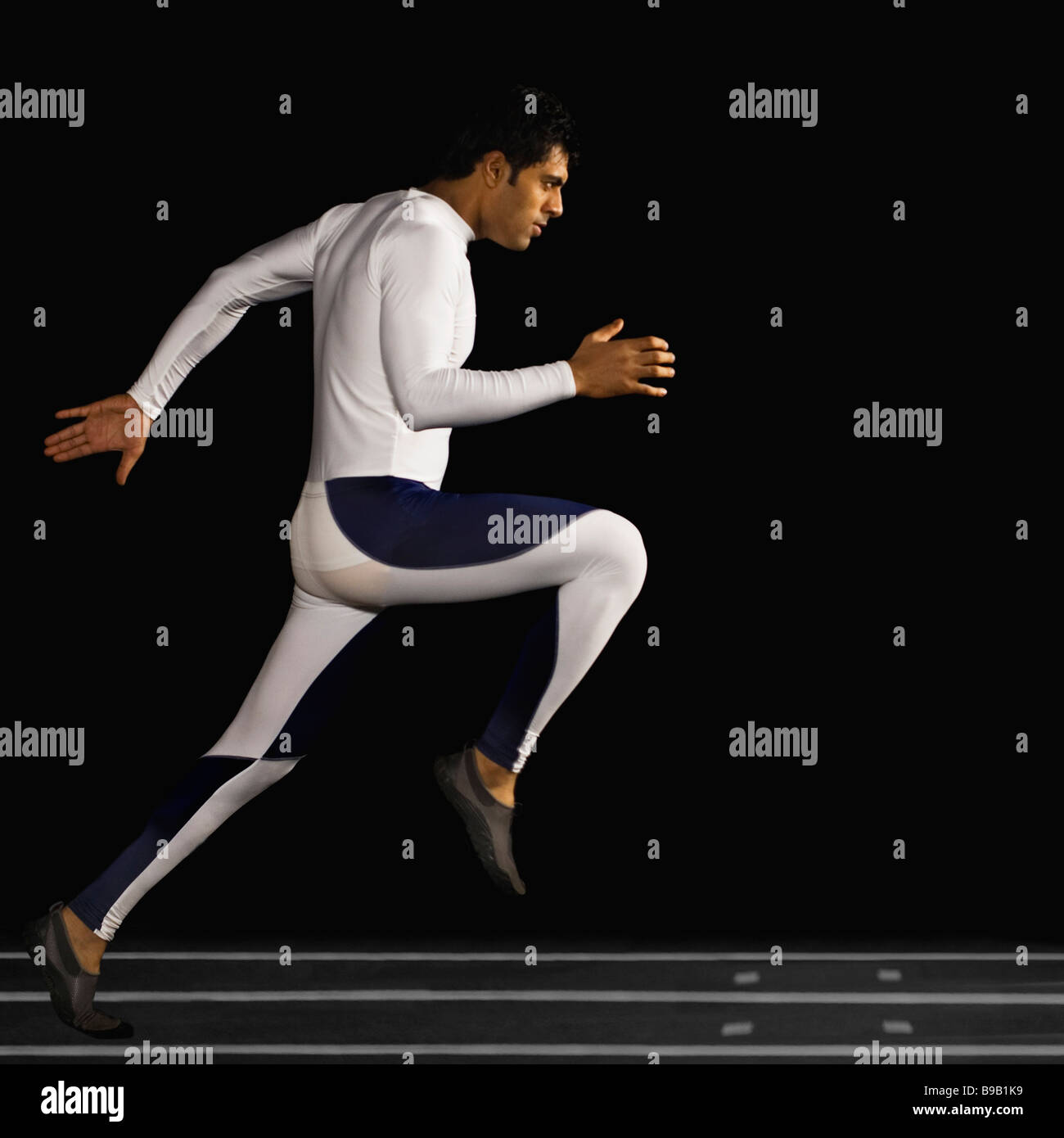 Male athlete running on track Stock Photo - Alamy