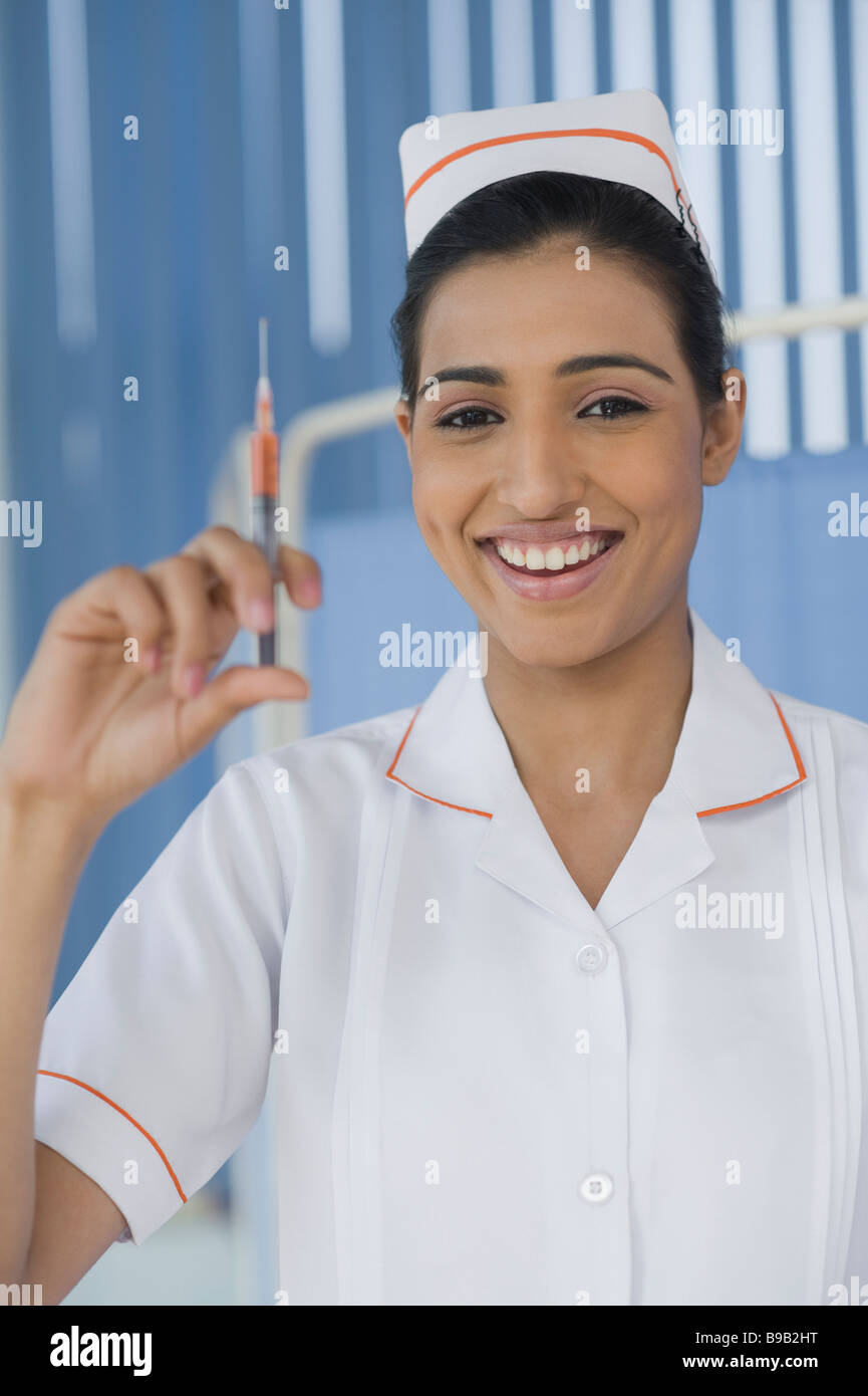 Female nurse holding a syringe Stock Photo - Alamy