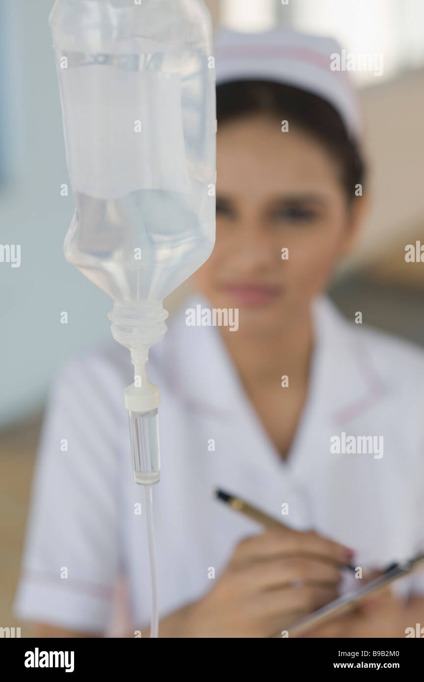 Female nurse checking a saline drip Stock Photo - Alamy