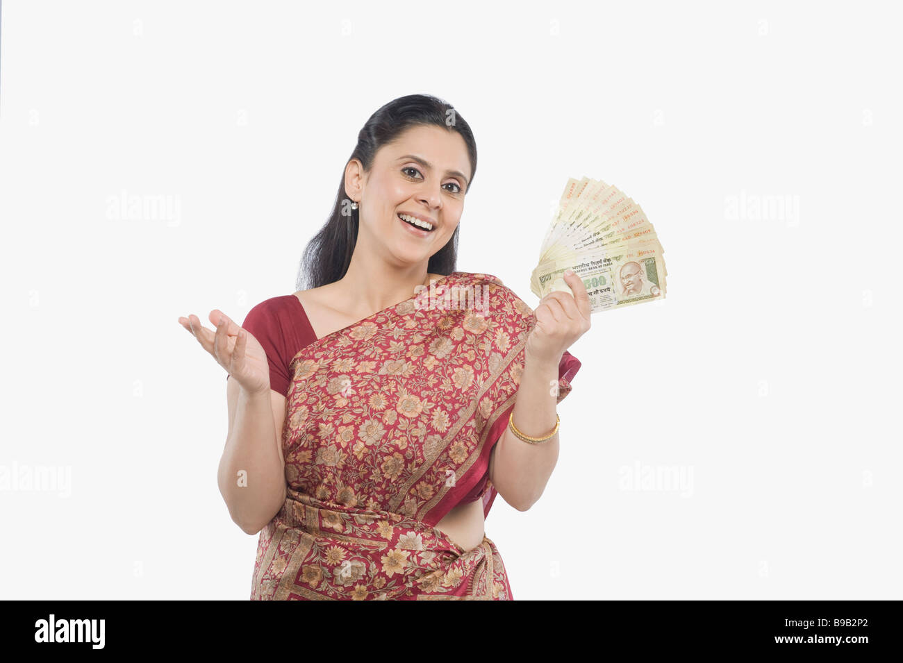 Woman holding currency notes Stock Photo - Alamy