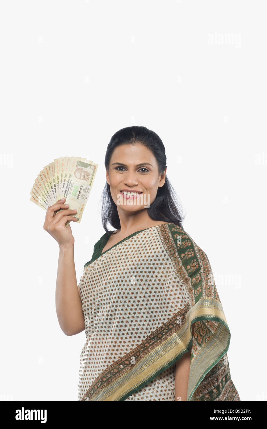 Woman holding currency notes Stock Photo - Alamy