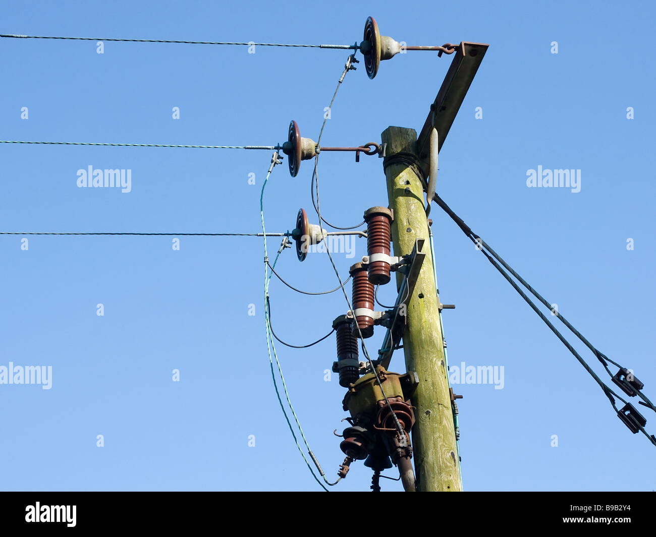 Telegraph pole set against blue sky Stock Photo - Alamy