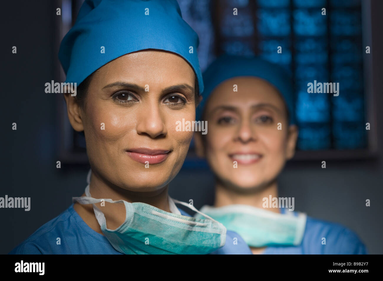 Portrait of two female surgeons smiling Stock Photo - Alamy