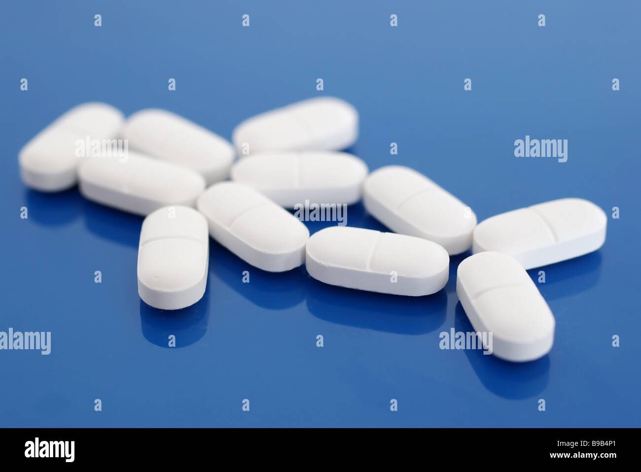 Human shape made out of pills on blue surface side view Stock Photo - Alamy
