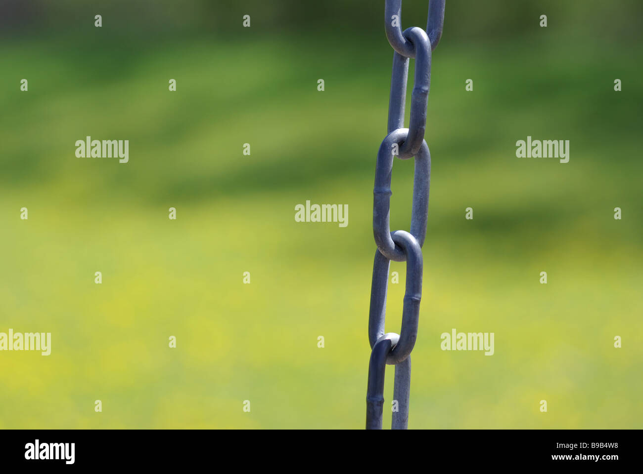 Chain against smooth green nature background Stock Photo - Alamy