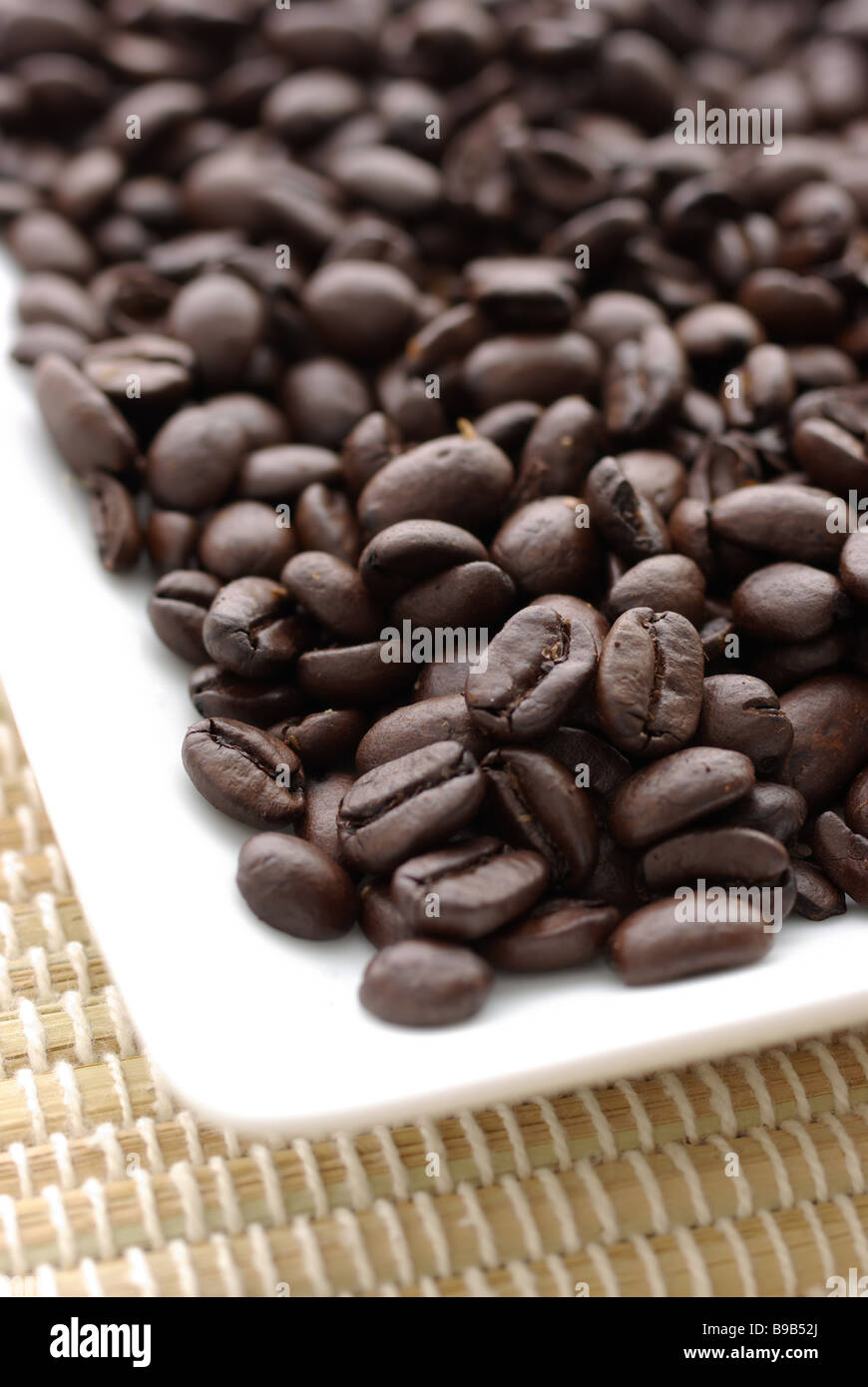 Roasted coffee beans on plate Stock Photo - Alamy