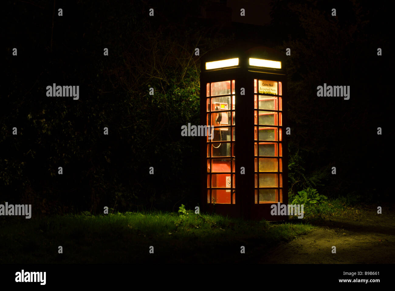 Red telephone box in rural location at night Stock Photo - Alamy