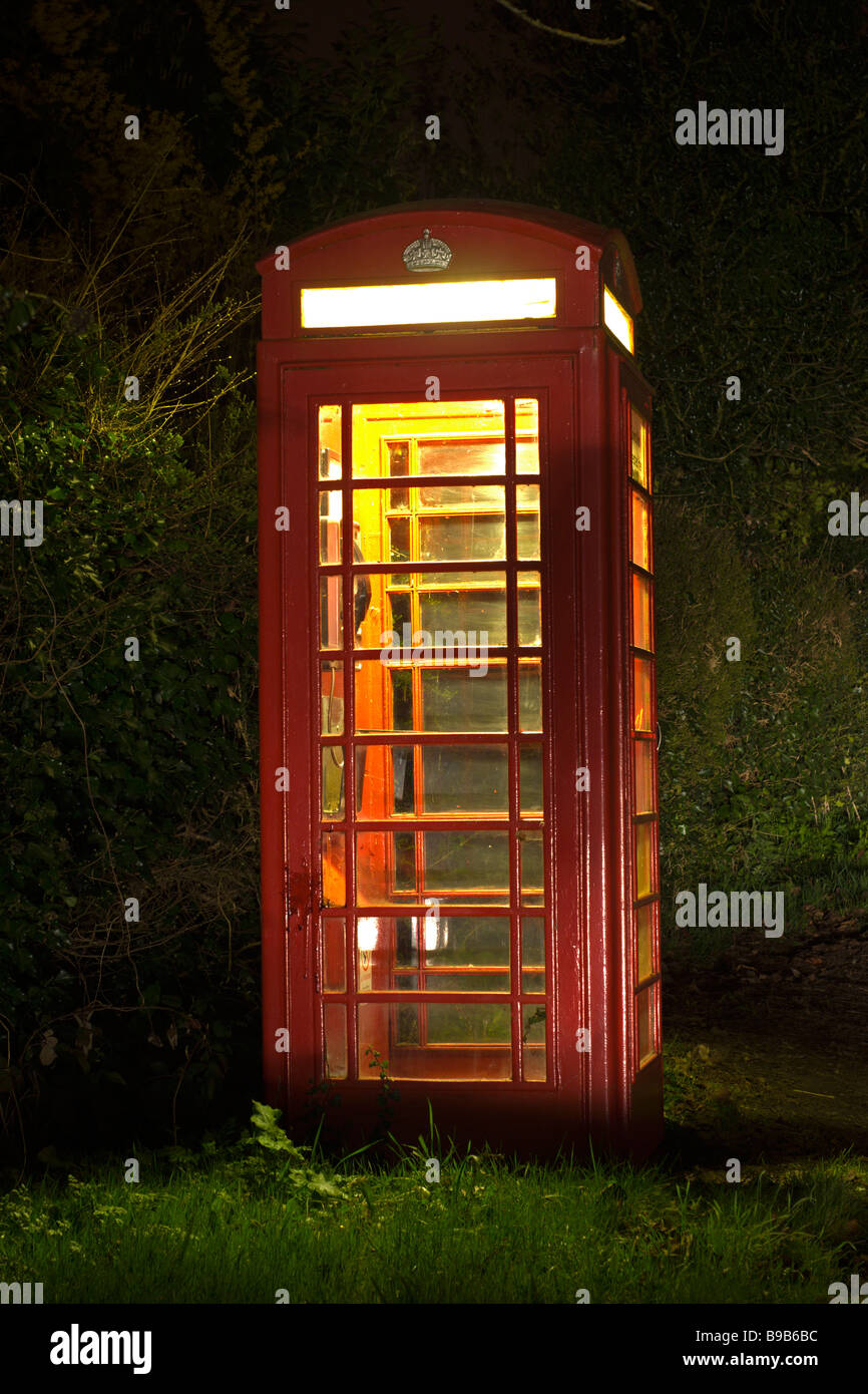 Red telephone box in rural location at night Stock Photo - Alamy