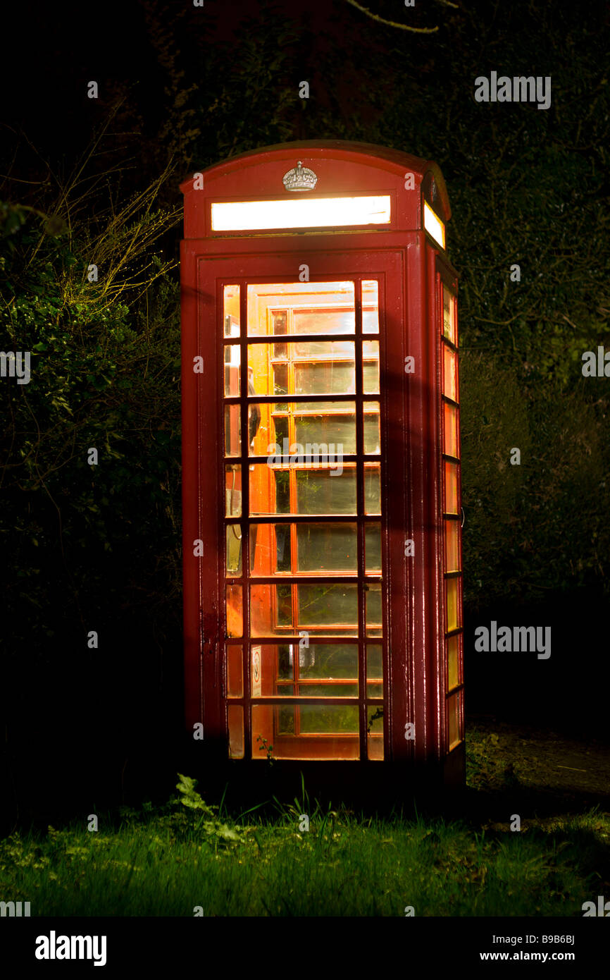 Red telephone box in rural location at night Stock Photo - Alamy