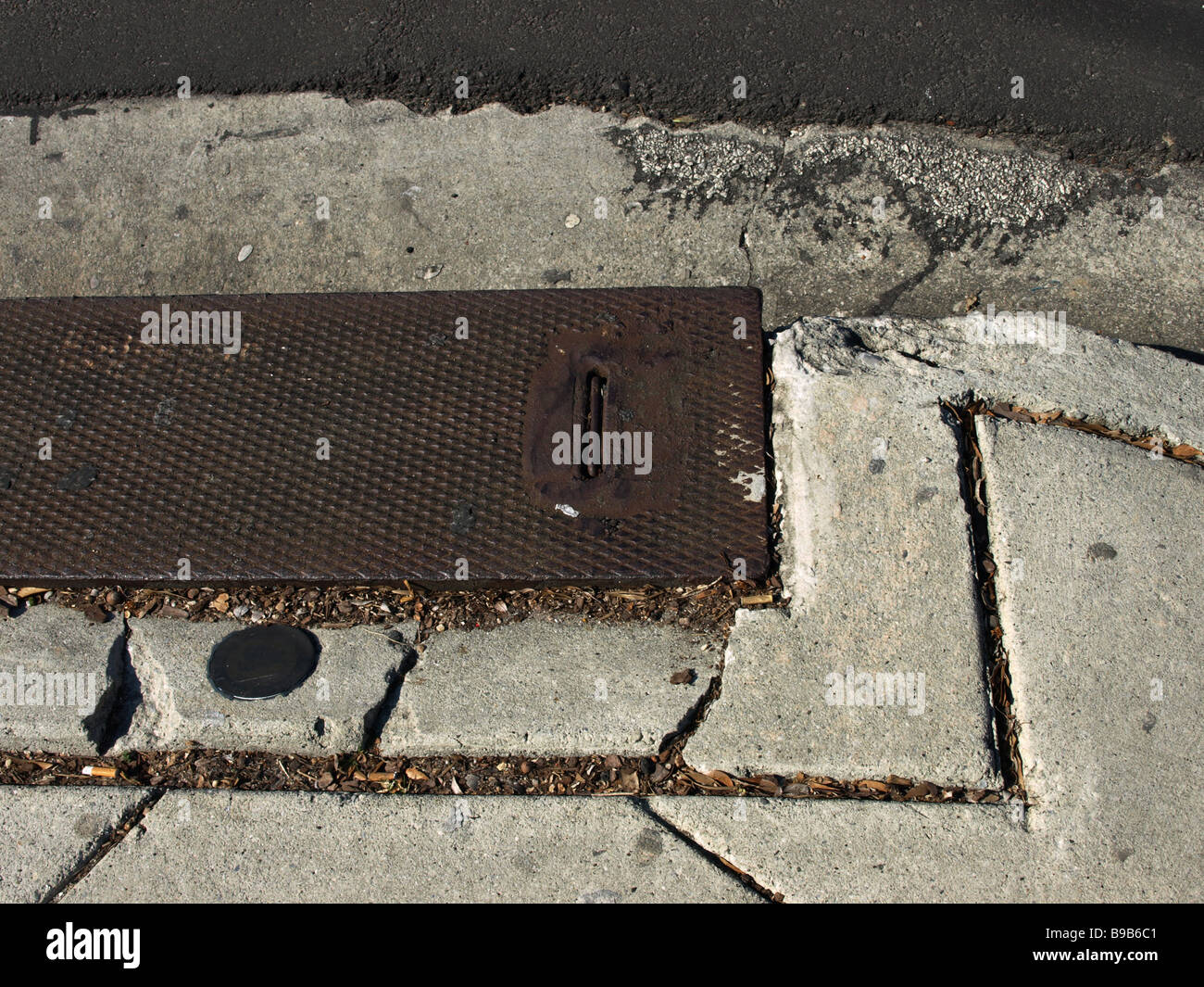 storm sewer structure on roadway with metal cap cement asphalt closeup ...