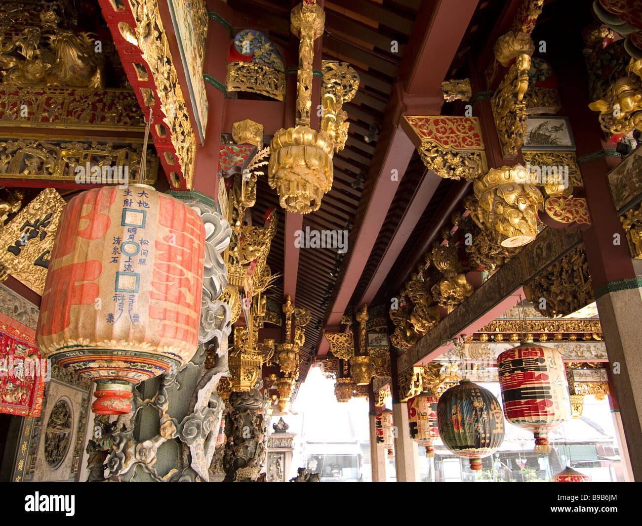 lanterns hang at the richly carved entrance to a Chinese Clan temple in ...