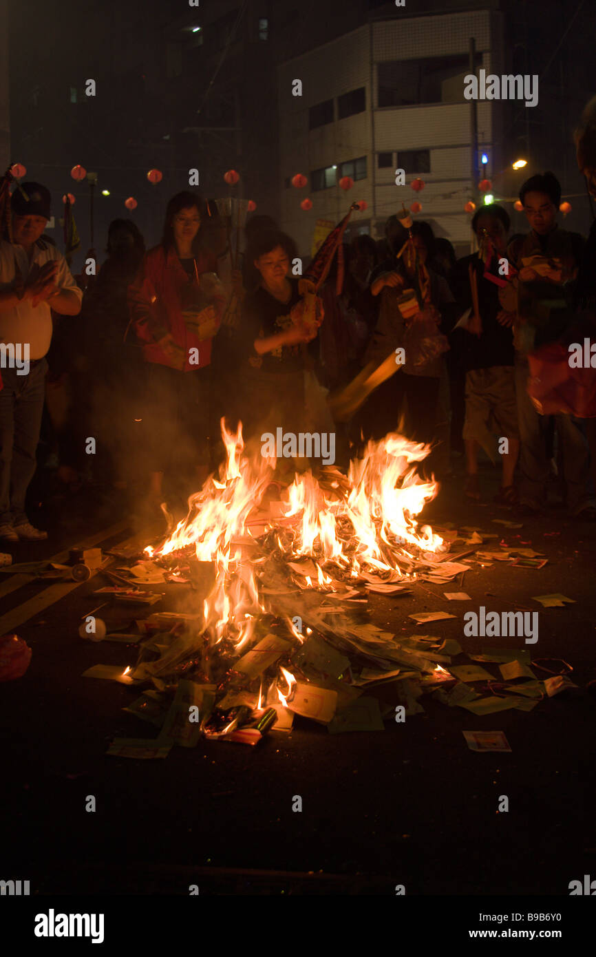 People burn sacrificial ghost money aka joss paper on the street during ...