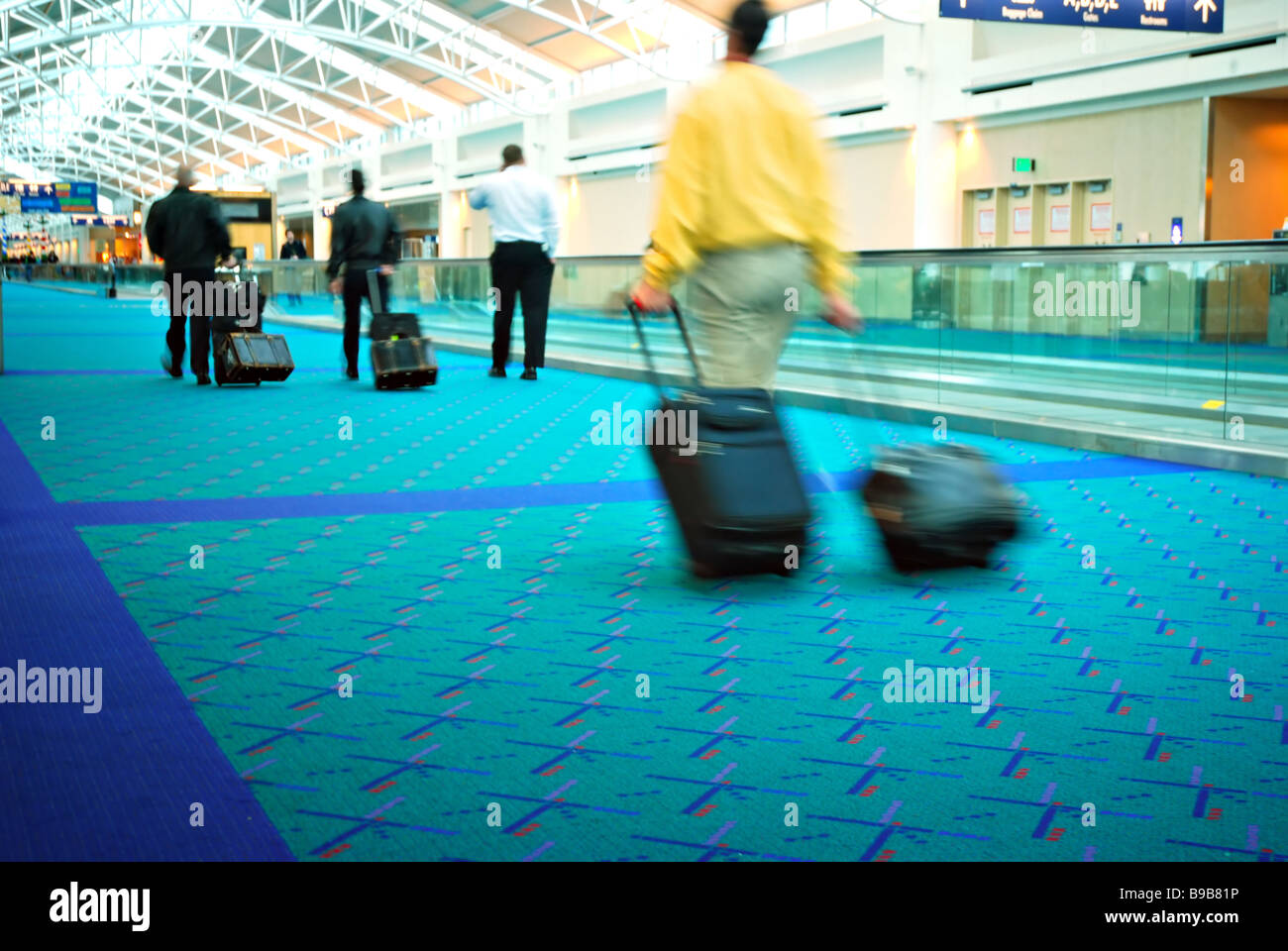 Travelers rushing through an airport terminal Stock Photo - Alamy