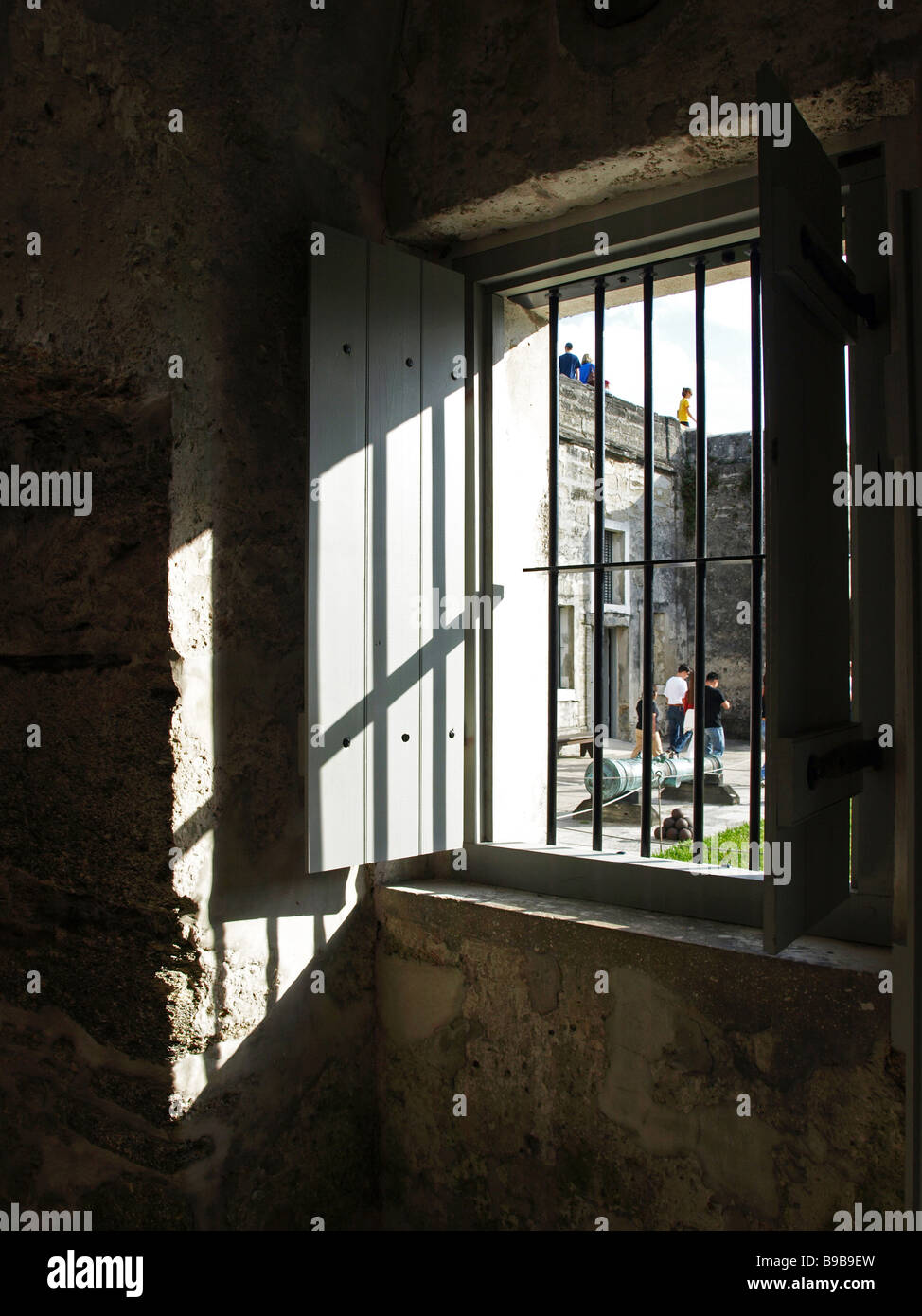 window bars stone wall looking out into courtyard fort shutters bright ...