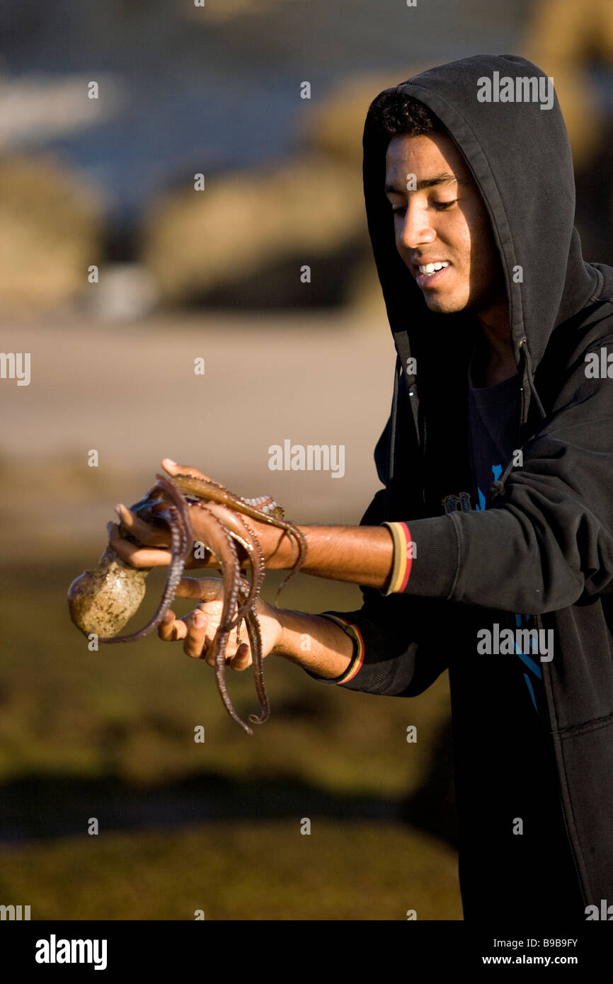 Young Moroccan man with octopus Stock Photo - Alamy
