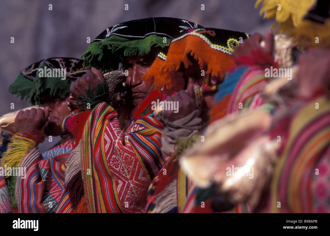 Quechua Indian men blowing conch shells as horns during Inti Raymi ...