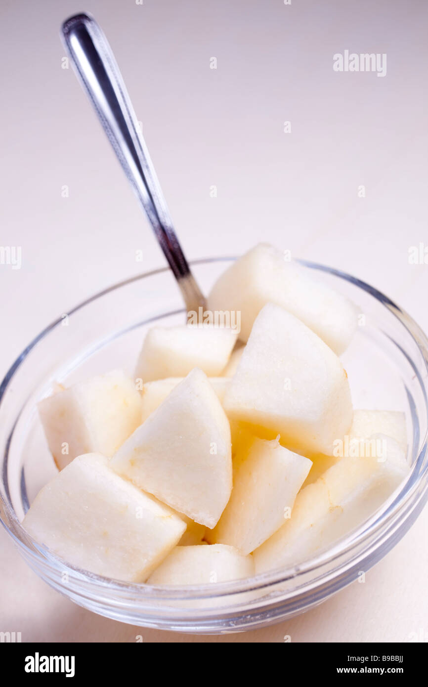 Pear cubes in a glass bowl with spoon Stock Photo - Alamy
