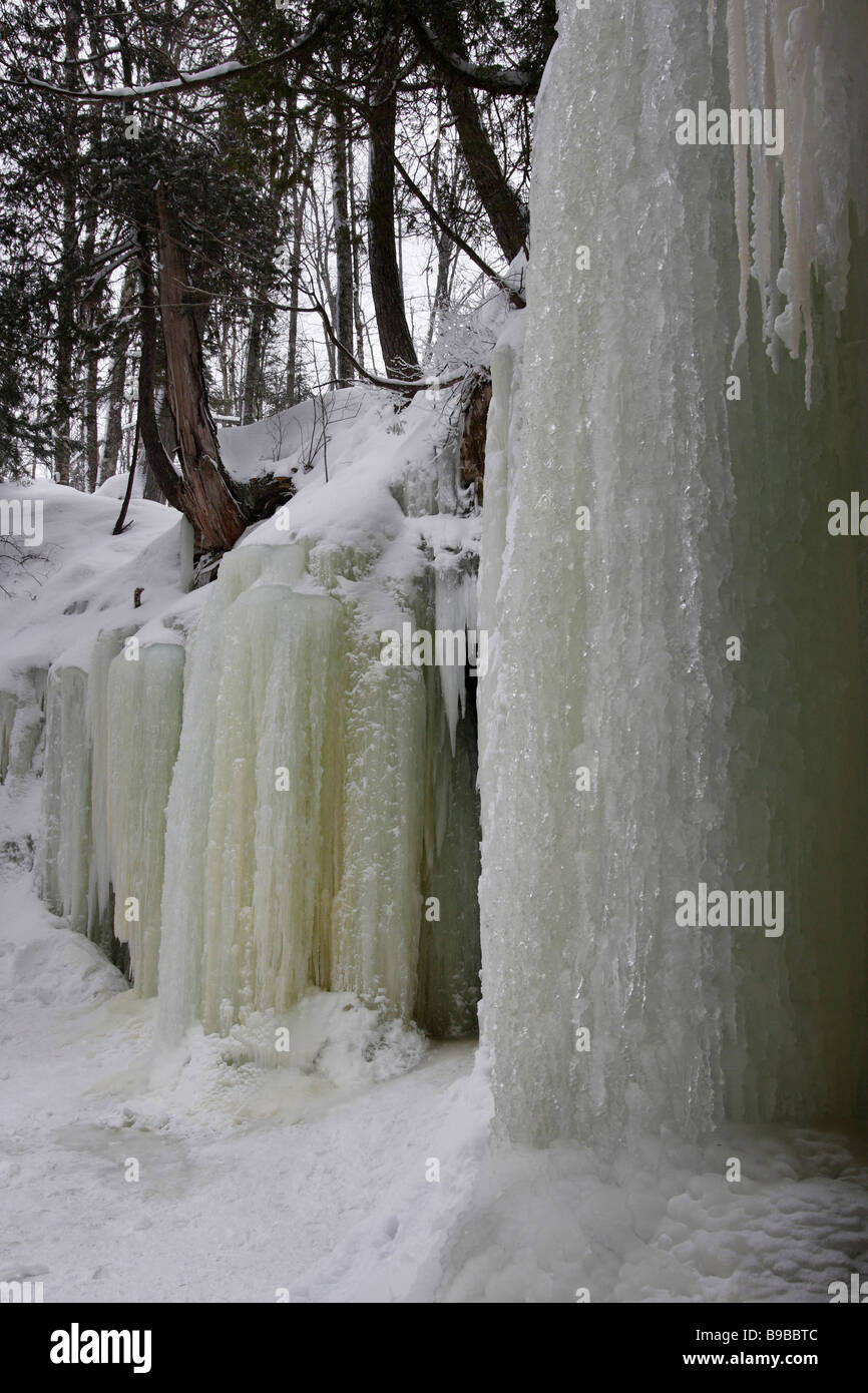 Rock River Canyon with frozen waterfall and snowy forest Michigan MI ...