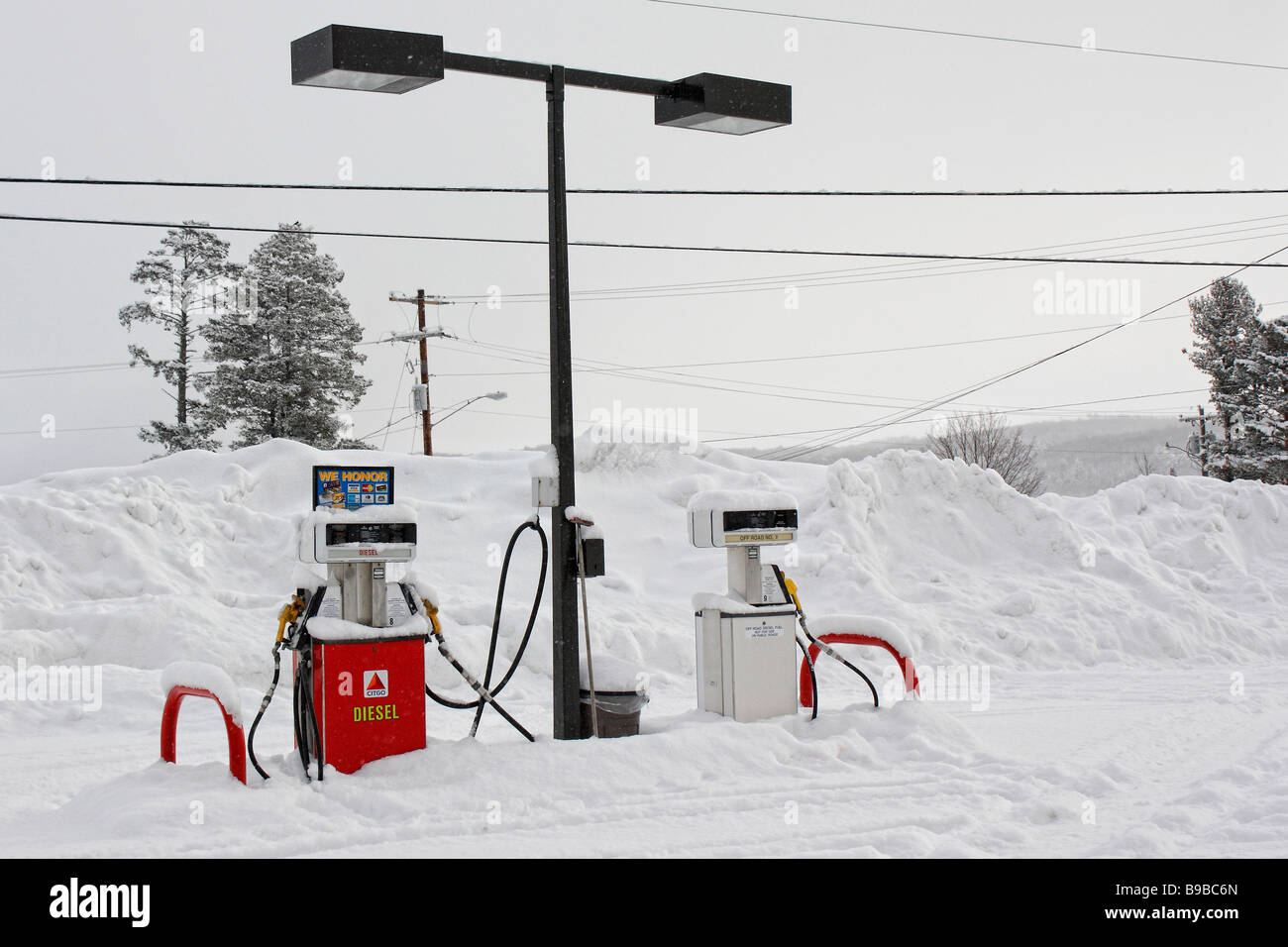 The rural gas station in a snow drift with street lamp winter in ...
