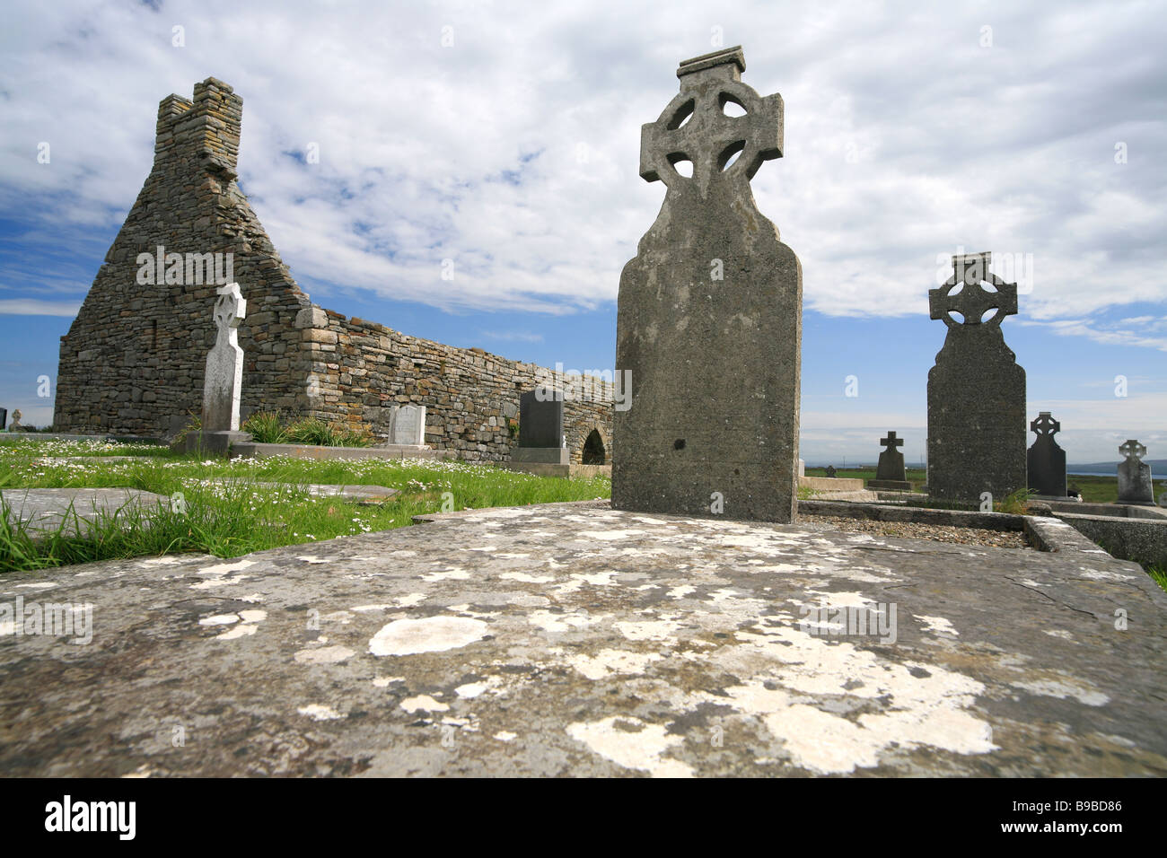tomb slab, Celtic crosses and ruin of a church on cemetery in Cross ...