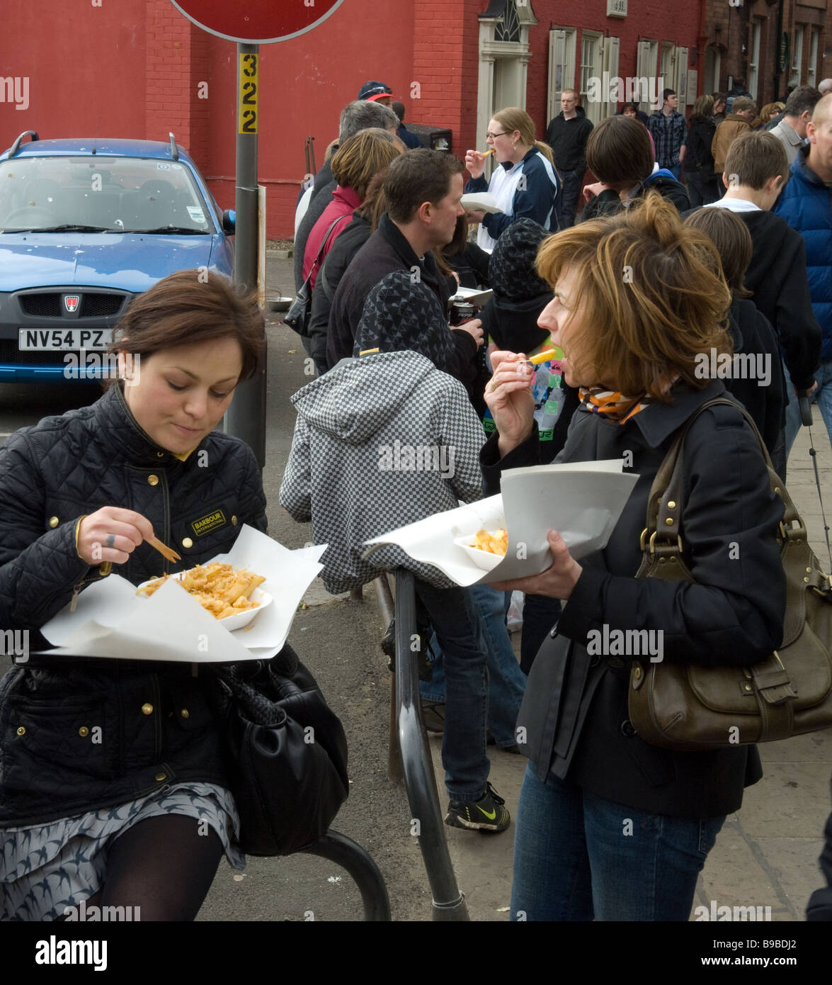 Fish and Chips being eaten outdoors from the paper Stock Photo - Alamy