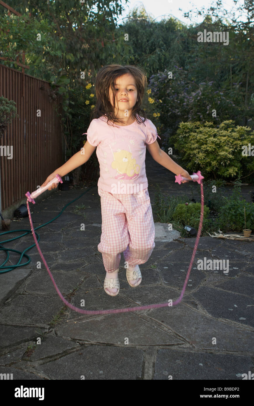 Happy girl skipping rope hi-res stock photography and images - Alamy