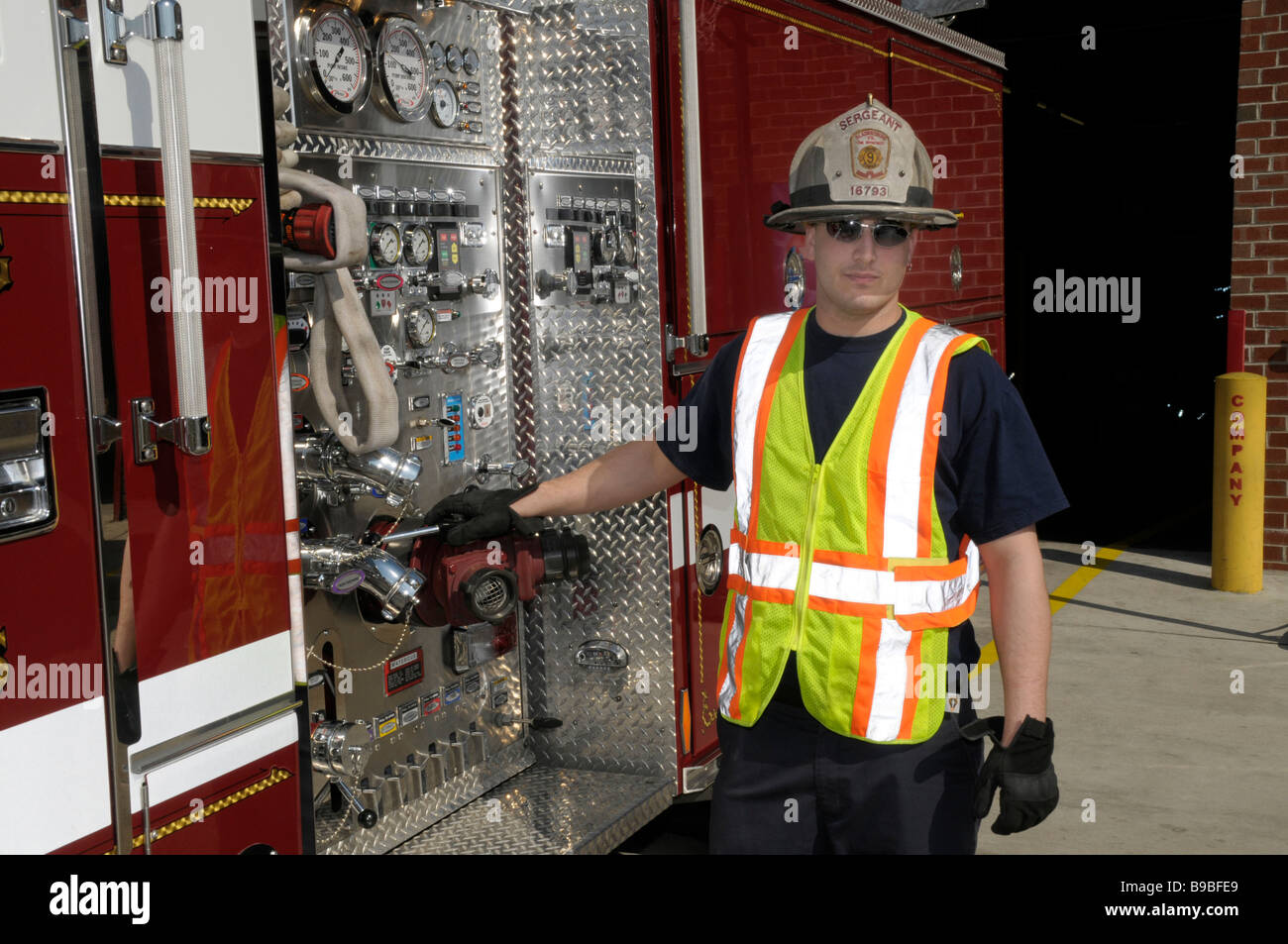 Firefighter operating the pumps Stock Photo - Alamy