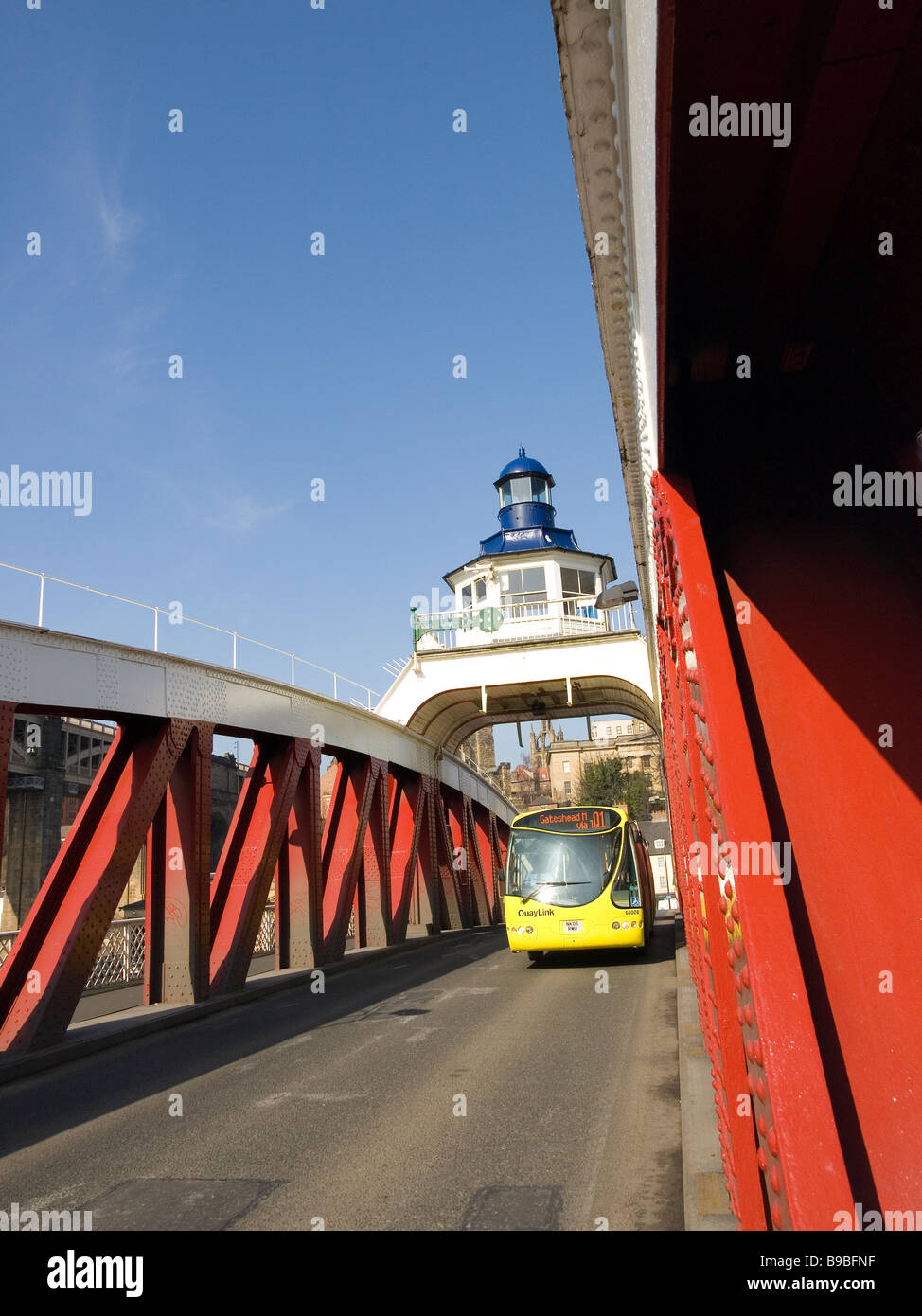 A modern eco friendly electric powered bus crossing the swing bridge ...