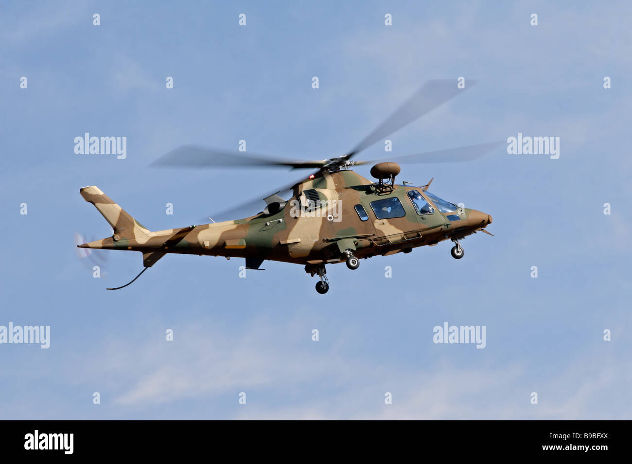 A camouflaged military helicopter in flight Stock Photo - Alamy