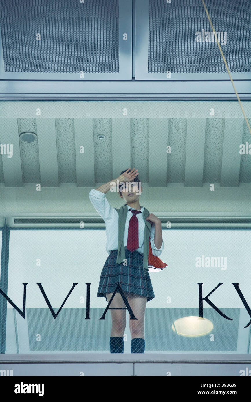 Female standing before window, looking out, low angle view Stock Photo ...