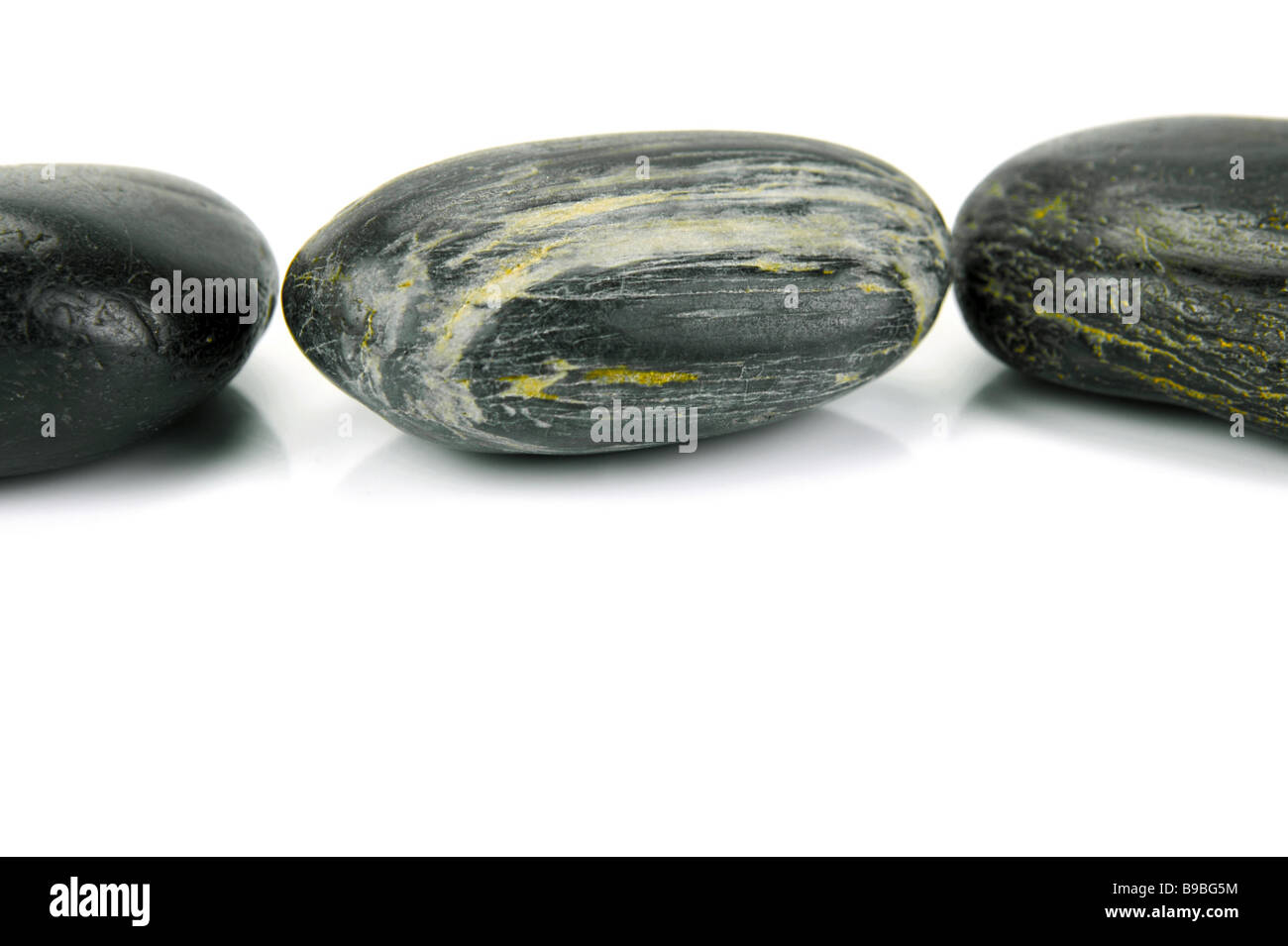 Black river rocks isolated against a white background Stock Photo - Alamy