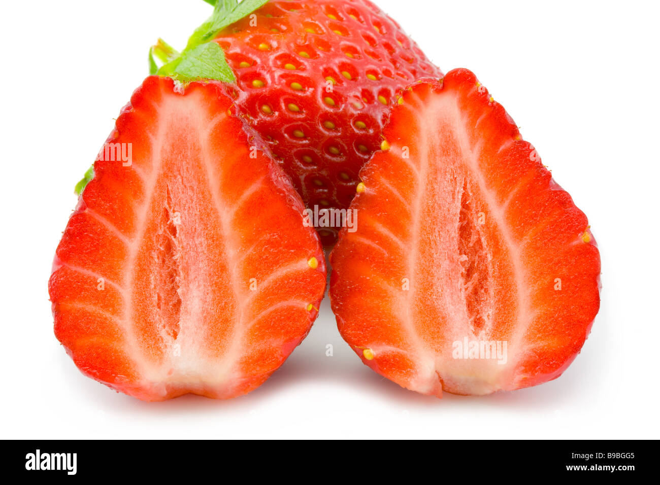 the two halfs and one full strawberry on white background Stock Photo ...