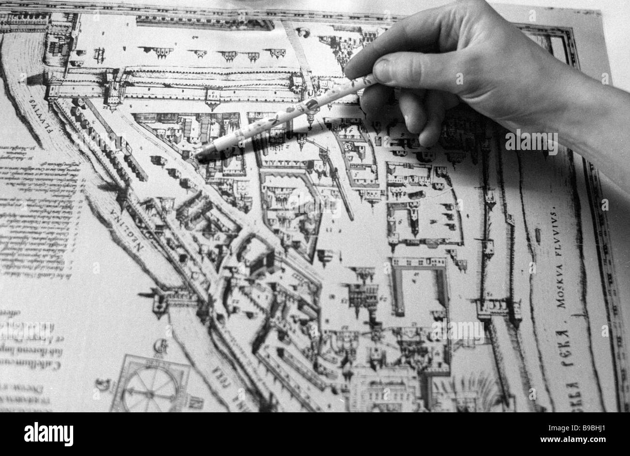 An archeologist points on an old Kremlin map the spot where a treasure ...