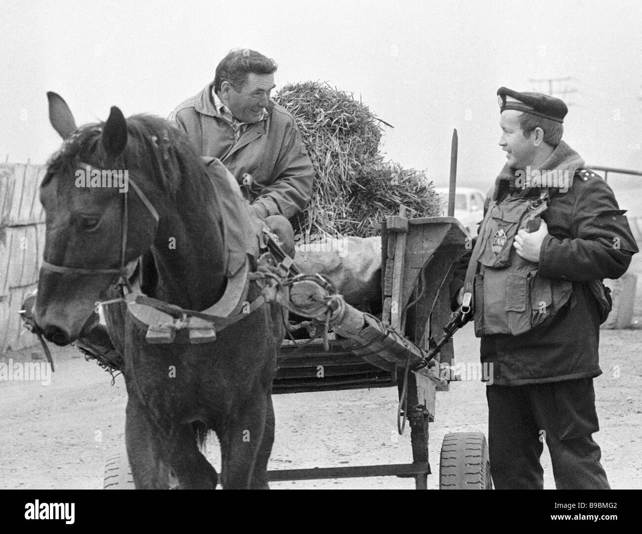 Militia officer verifying documents of an Ingush at one of the ...