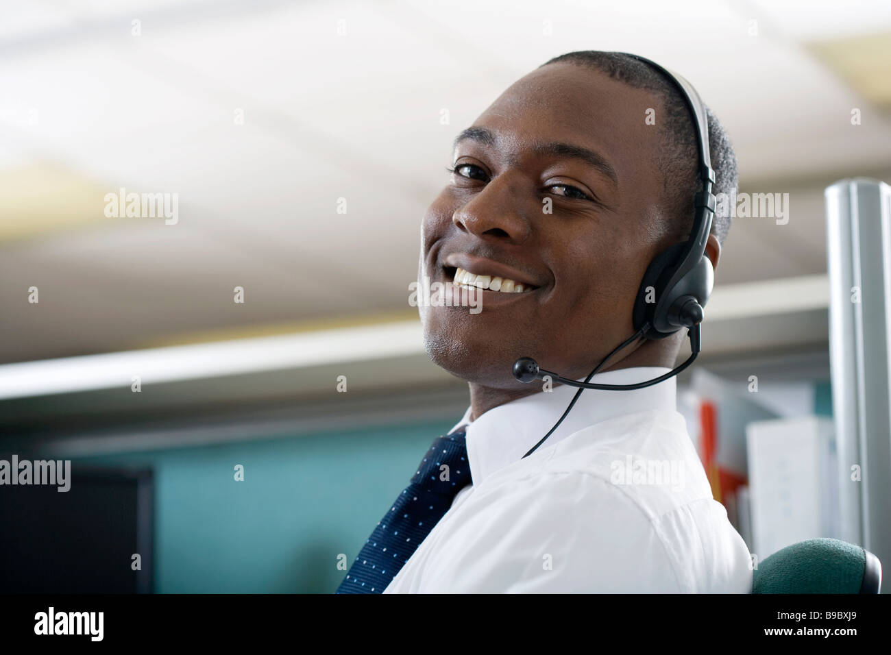 Businessman talking on headset Stock Photo - Alamy