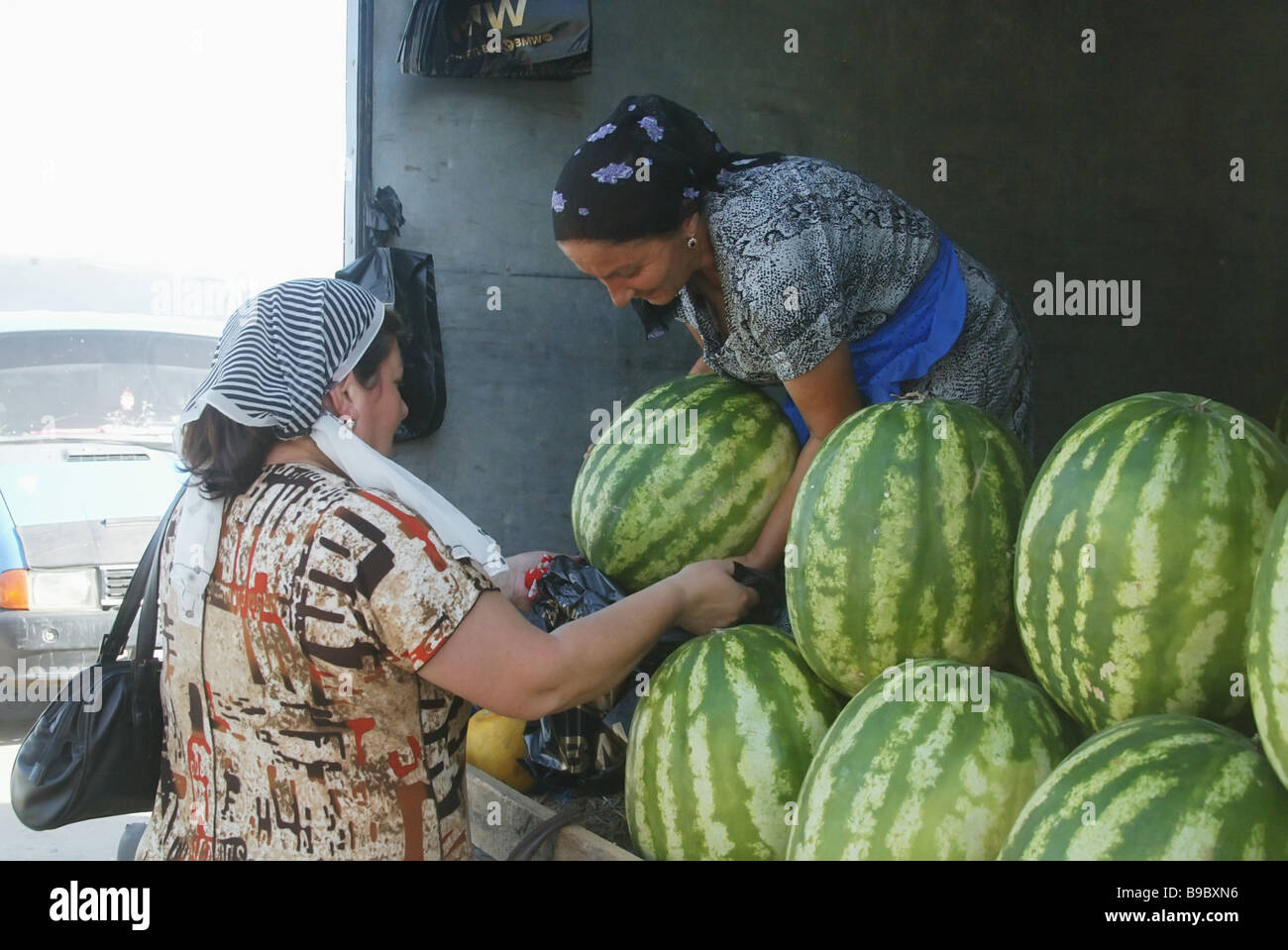 Watermelon vendor and customer in Grozny Chechnya Stock Photo - Alamy