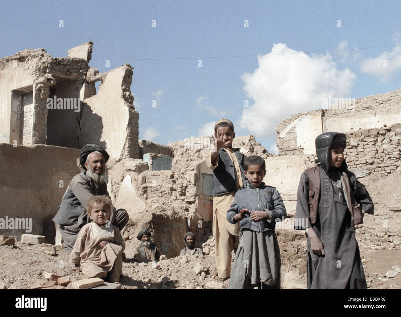 Kandahar residents on site of their demolished house Stock Photo - Alamy