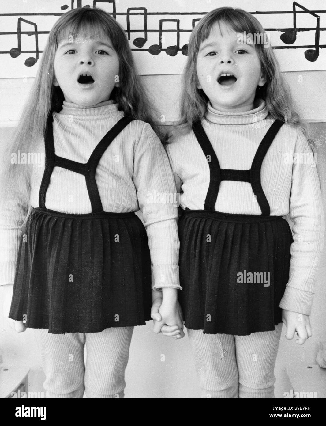 Twin girls singing Stock Photo - Alamy