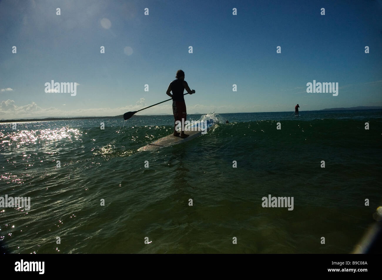 Surfer paddling out into the waves hi-res stock photography and images ...