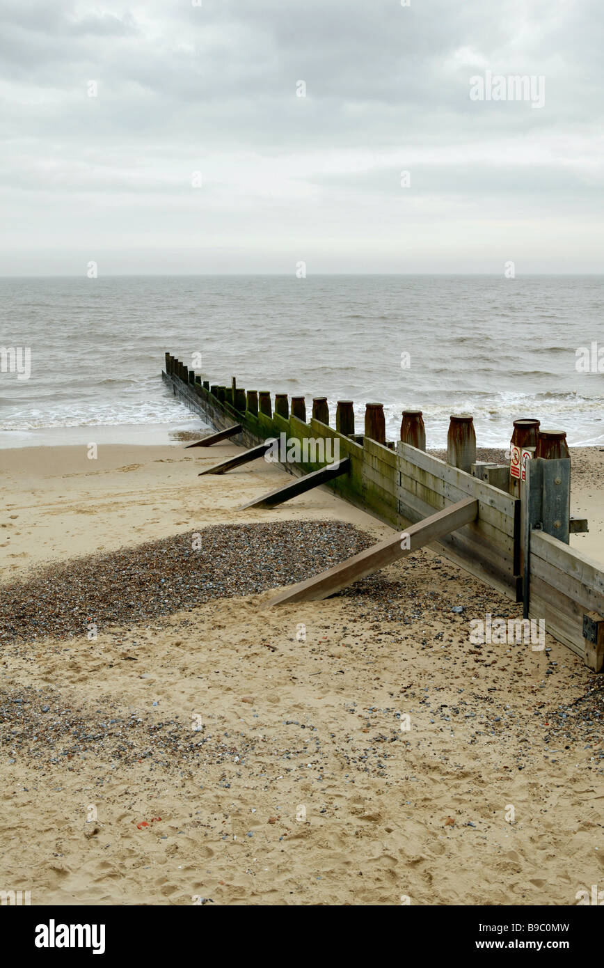 Angle view of east coast beach in uk featuring a large sea groyne ...
