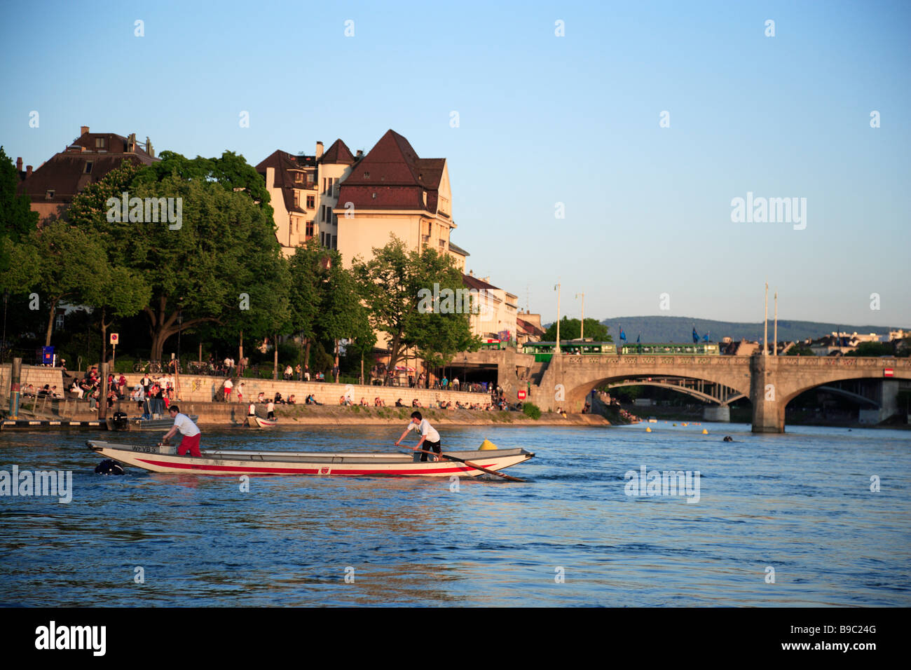 Two men in a rowing boat on river Rhine Mittlere Rheinbrücke middle ...
