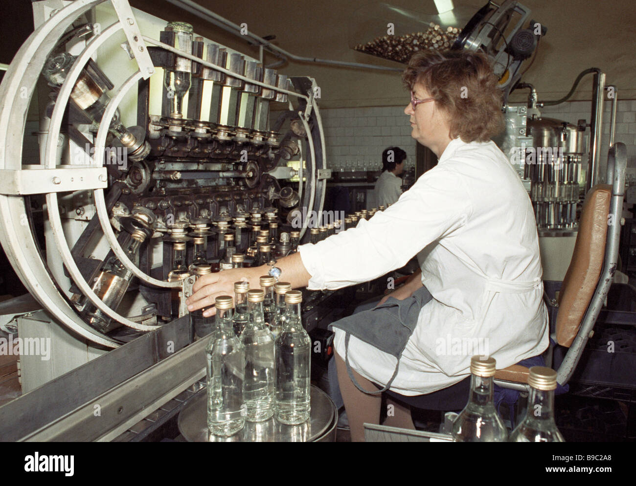 Handling the automatic bottling line at the Crystal distillery Stock ...