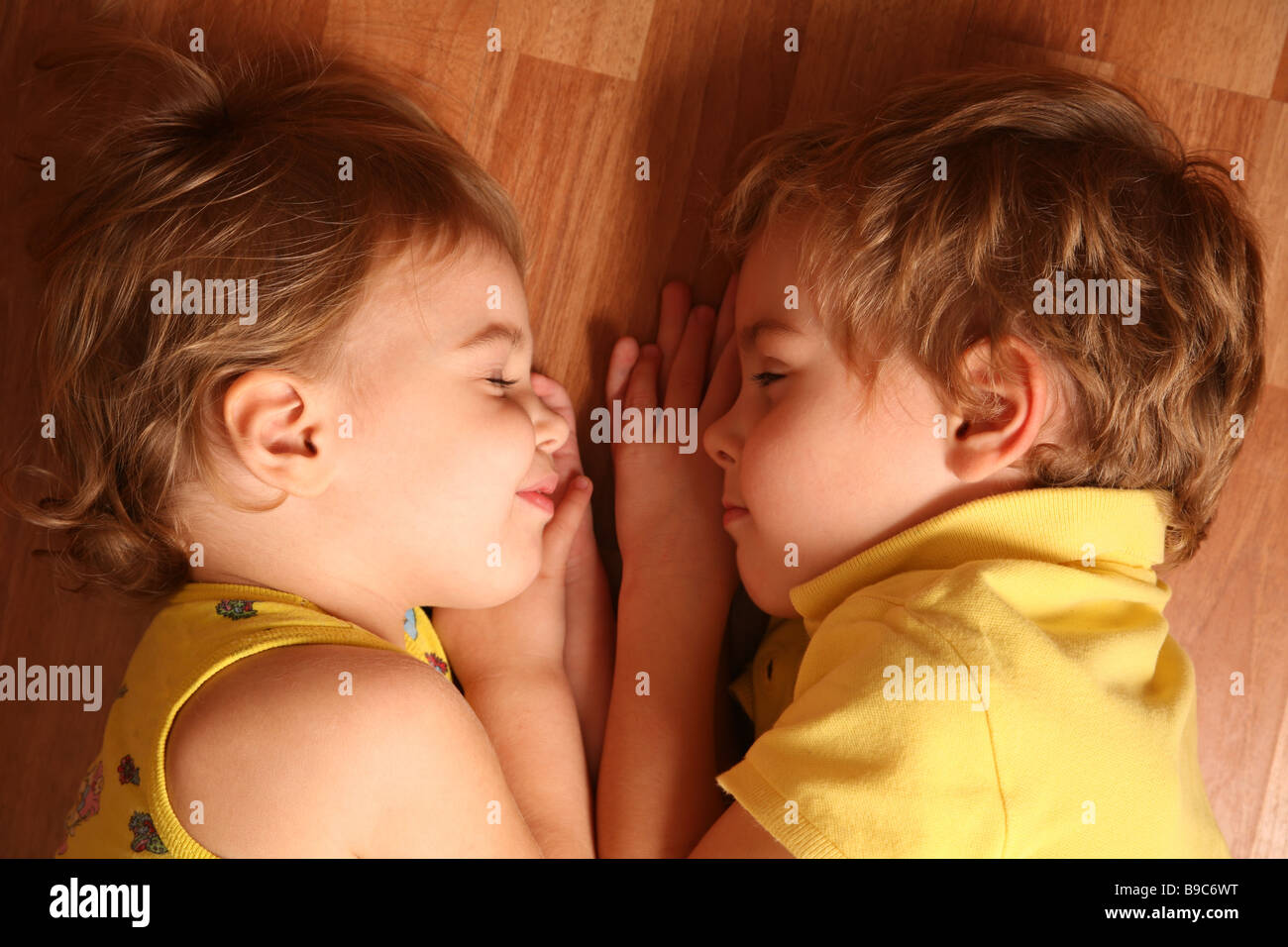 two children sleep on floor Stock Photo - Alamy