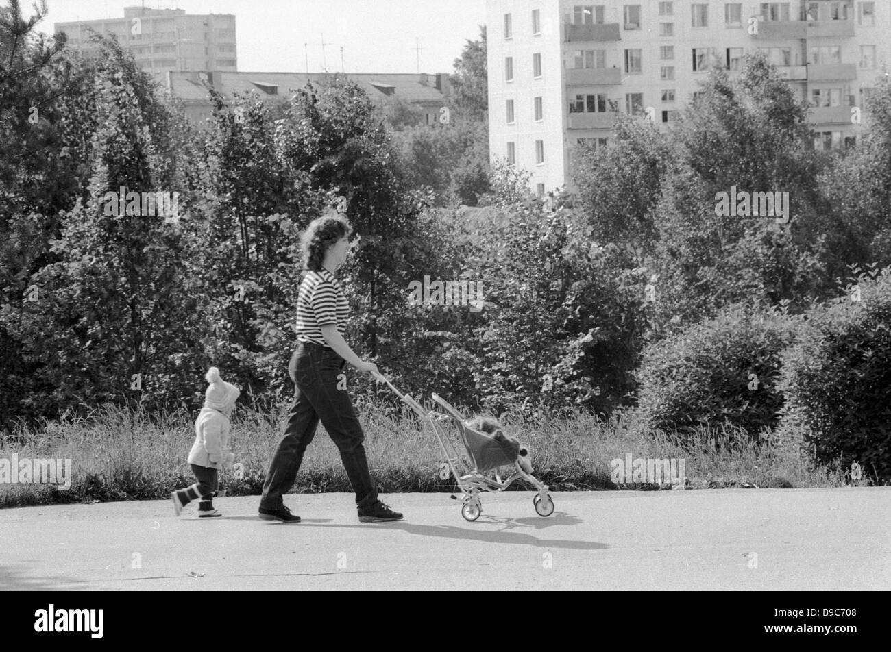 Young woman on a stroll with her child Stock Photo - Alamy