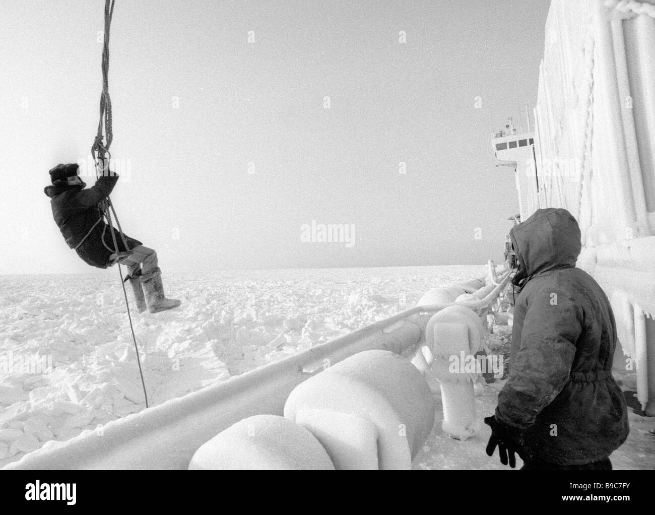 First mate of motor ship Arkhangelsk steps on ice to examine hull ...