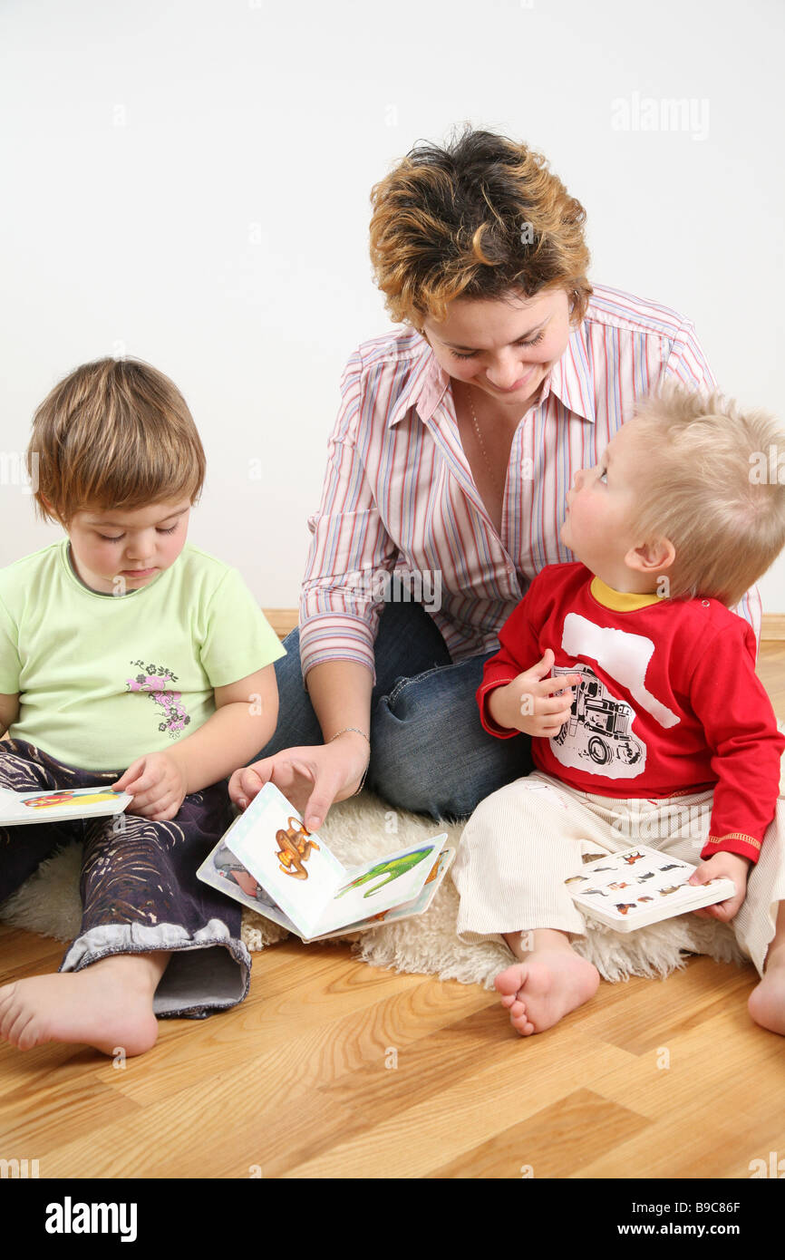children looking books with mother 2 Stock Photo - Alamy