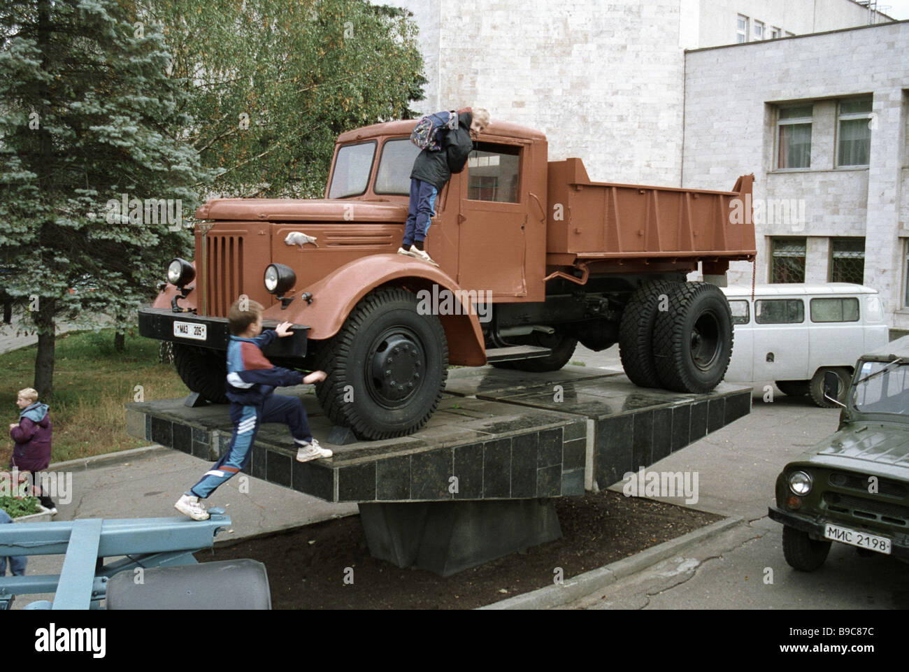 Children looking at a truck of the first family of MAZ 205 vehicles ...